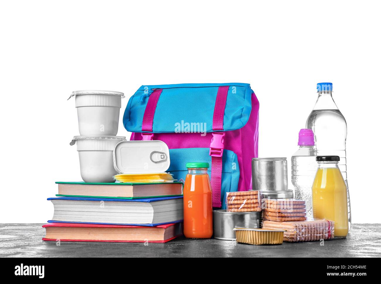 Schoolbag with different products on table against white background ...