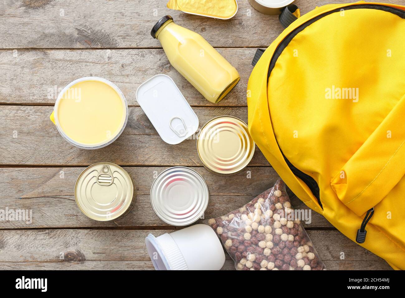 Schoolbag with different products on table. Concept of Backpack Food ...