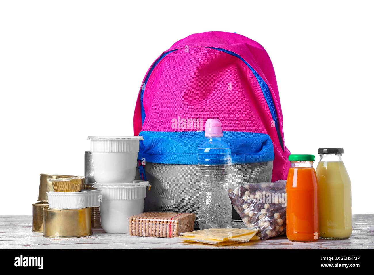 Schoolbag with different products on table against white background ...