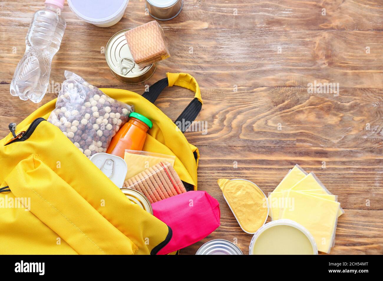 Schoolbag with different products on table. Concept of Backpack Food ...