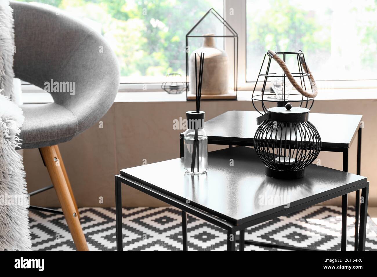 Table with air freshener in interior of living room Stock Photo - Alamy