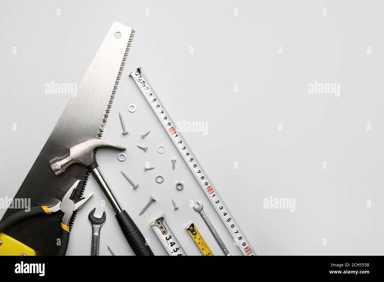 Measuring tapes with builder's supplies on white background Stock Photo ...