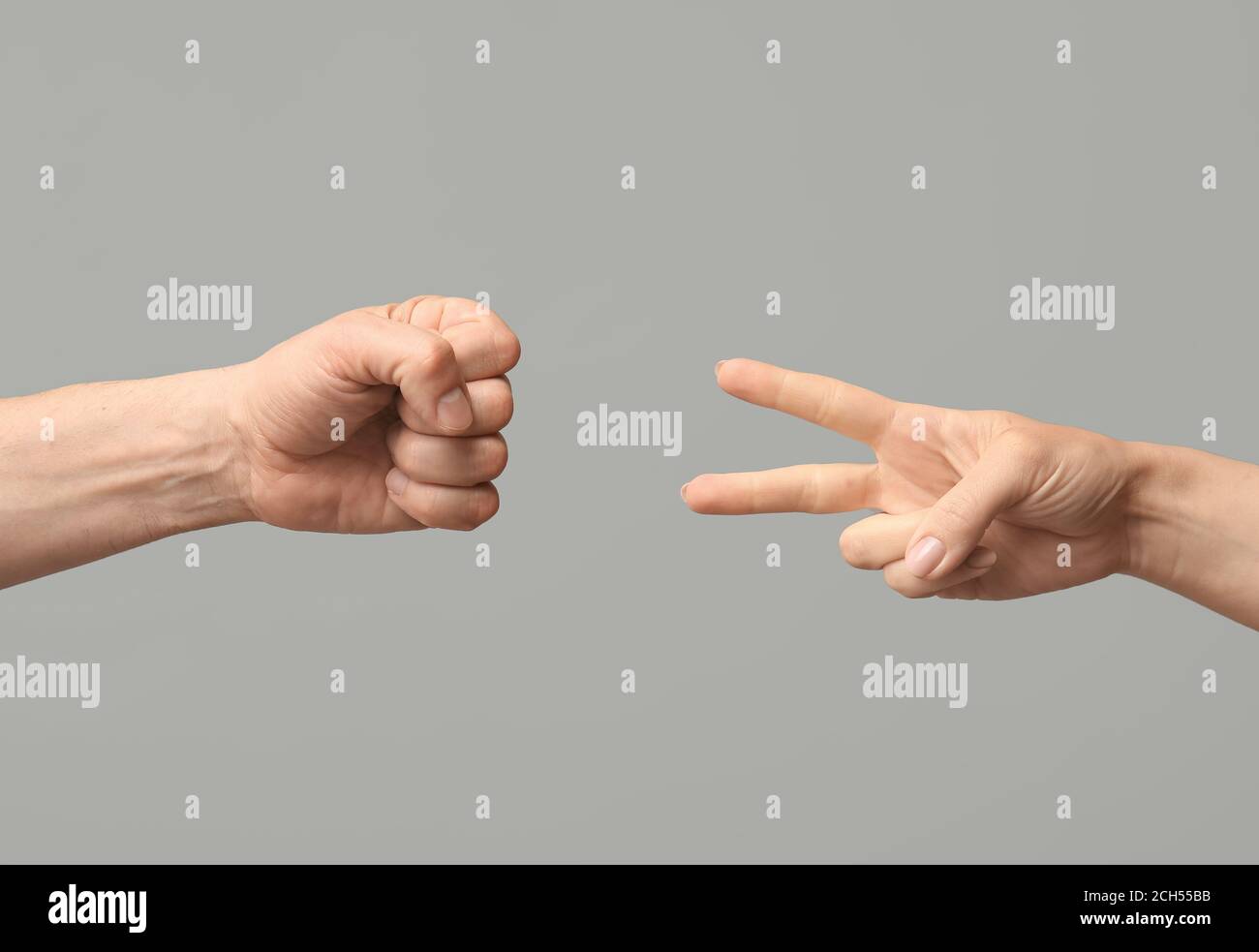 People playing roshambo game on grey background Stock Photo - Alamy