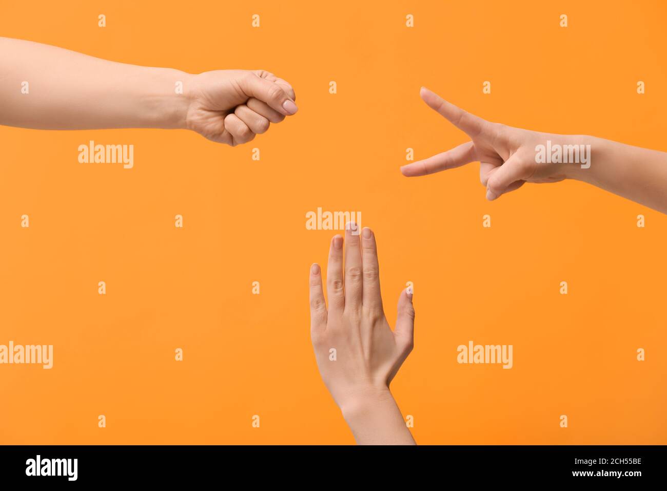 People playing roshambo game on color background Stock Photo - Alamy