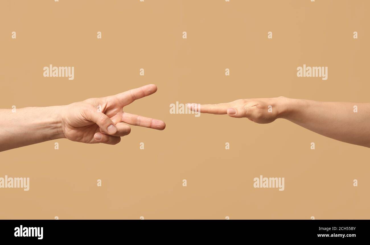 People playing roshambo game on color background Stock Photo - Alamy