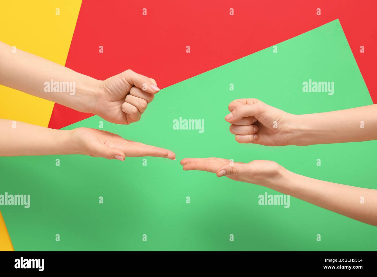 People playing roshambo game on color background Stock Photo - Alamy