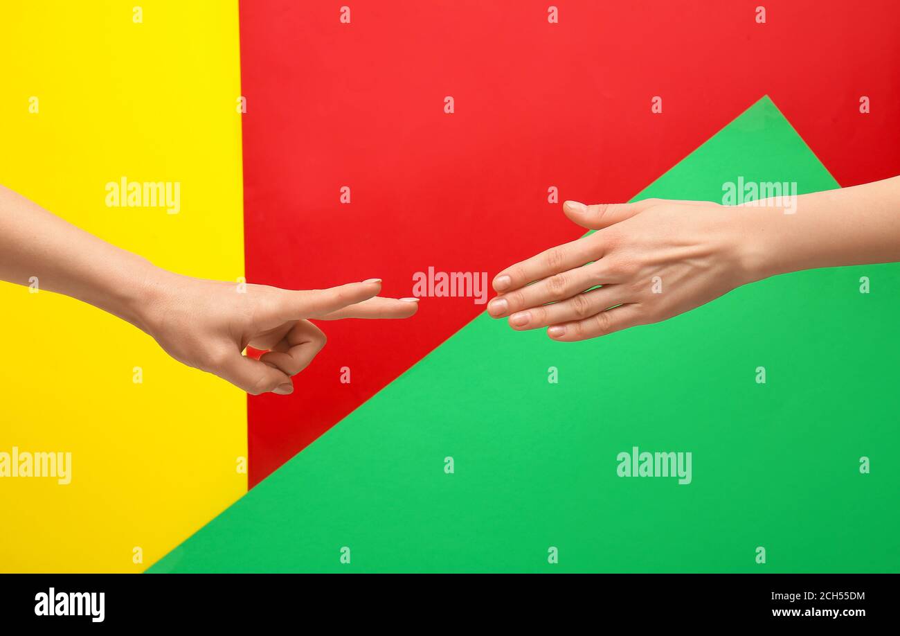 People playing roshambo game on color background Stock Photo - Alamy
