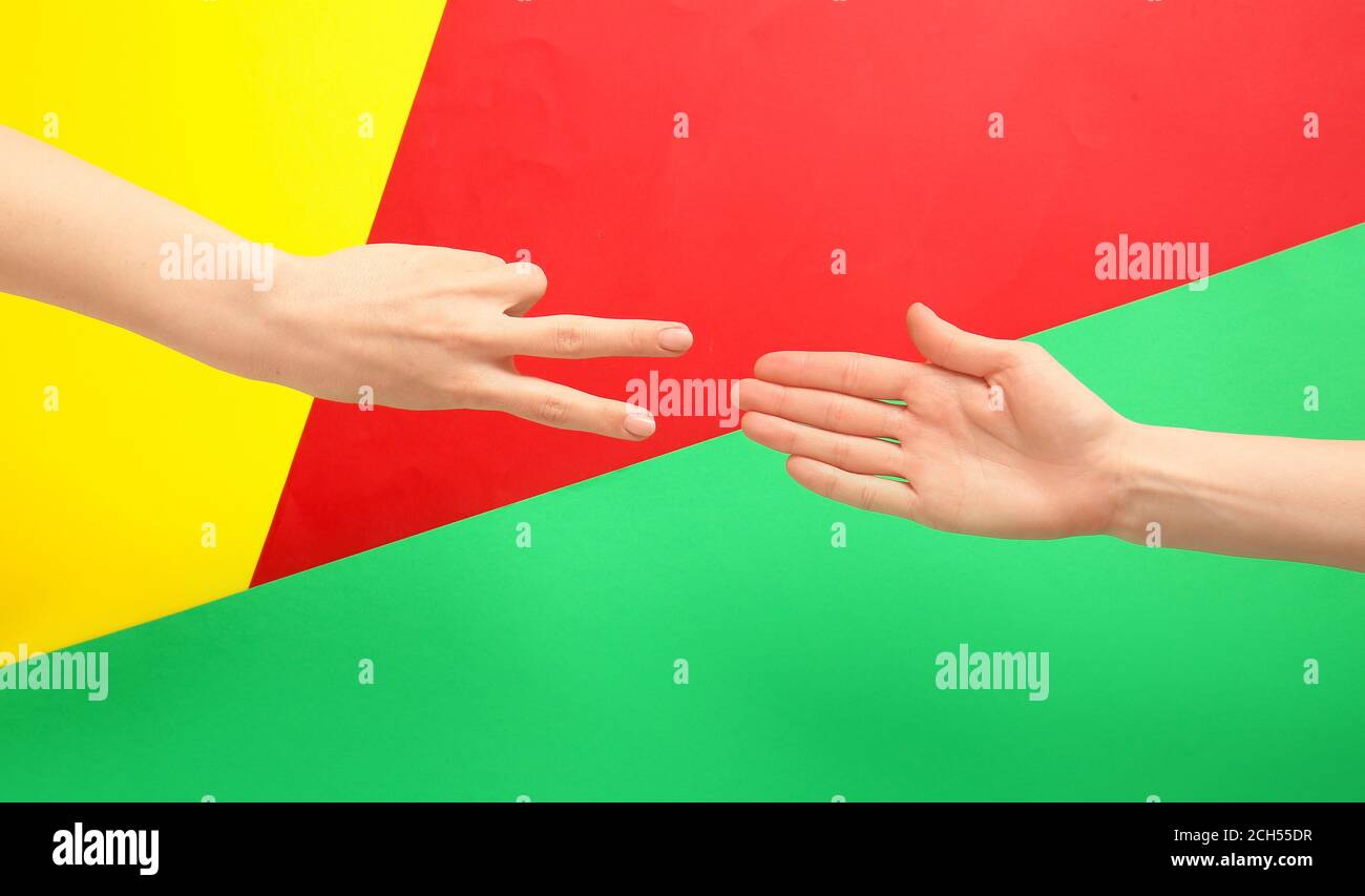People playing roshambo game on color background Stock Photo - Alamy