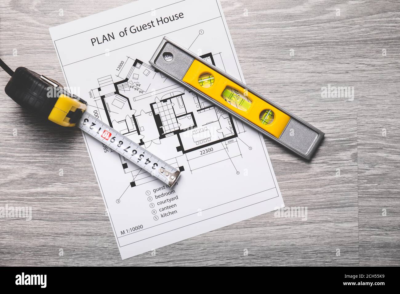 Measuring tape with ruler and blueprint on table Stock Photo - Alamy