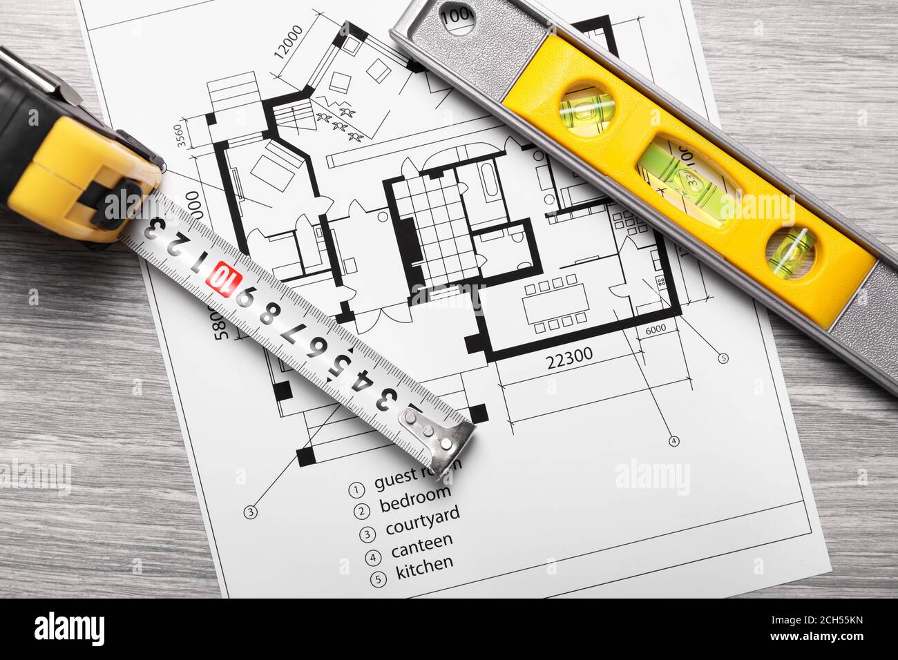Measuring tape with ruler and blueprint on table Stock Photo - Alamy