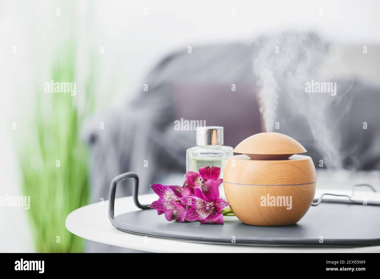 Aroma oil diffuser on table in room Stock Photo - Alamy