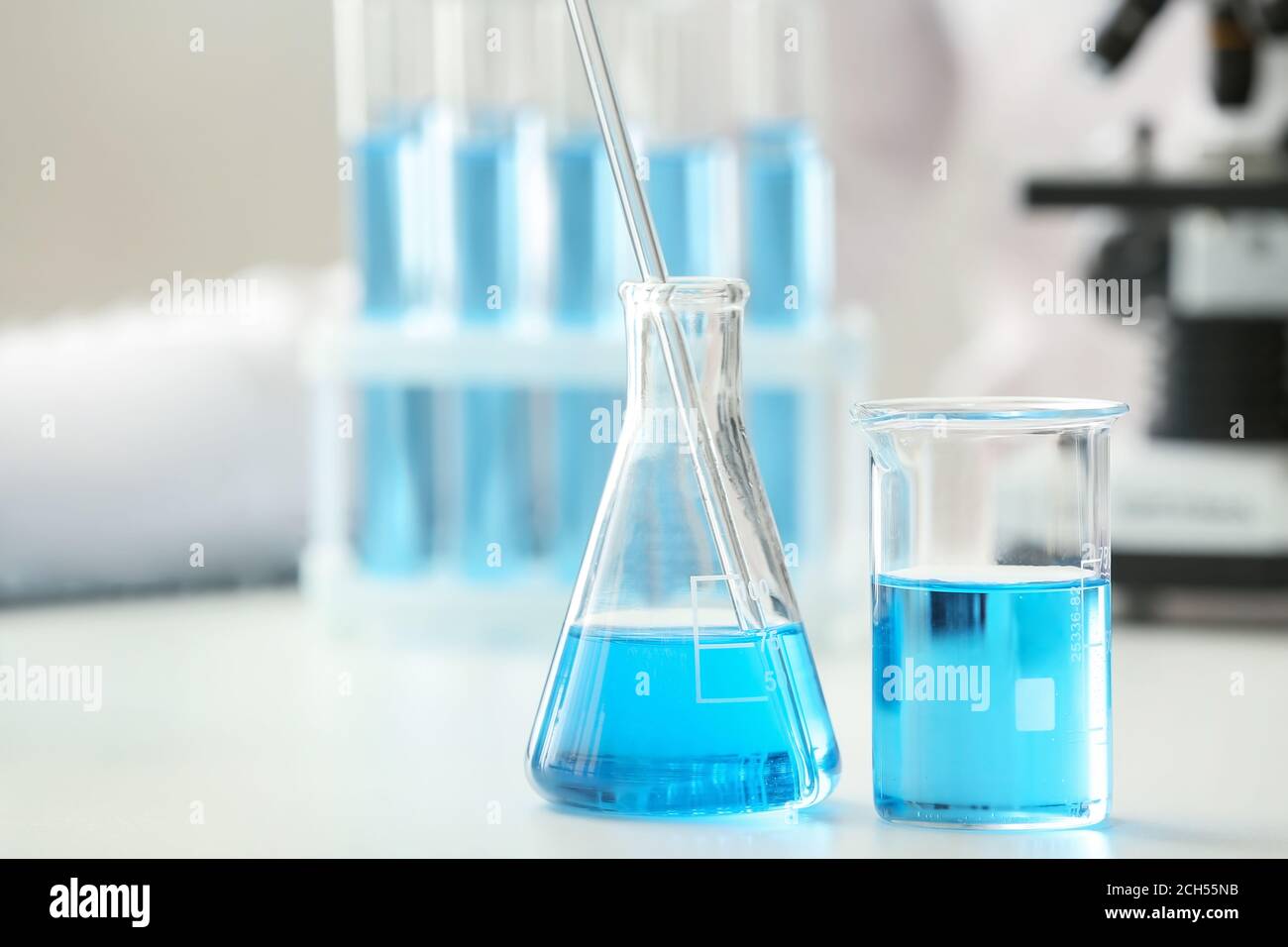 Glassware on table in laboratory Stock Photo - Alamy