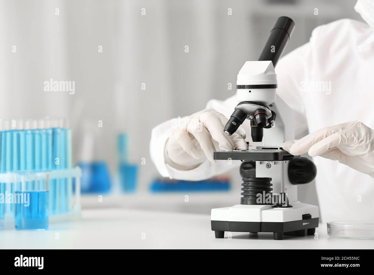 Scientist using microscope in laboratory Stock Photo - Alamy
