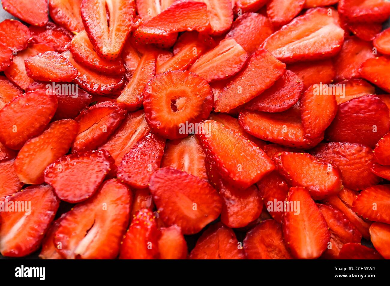 Cut fresh strawberry as background Stock Photo - Alamy