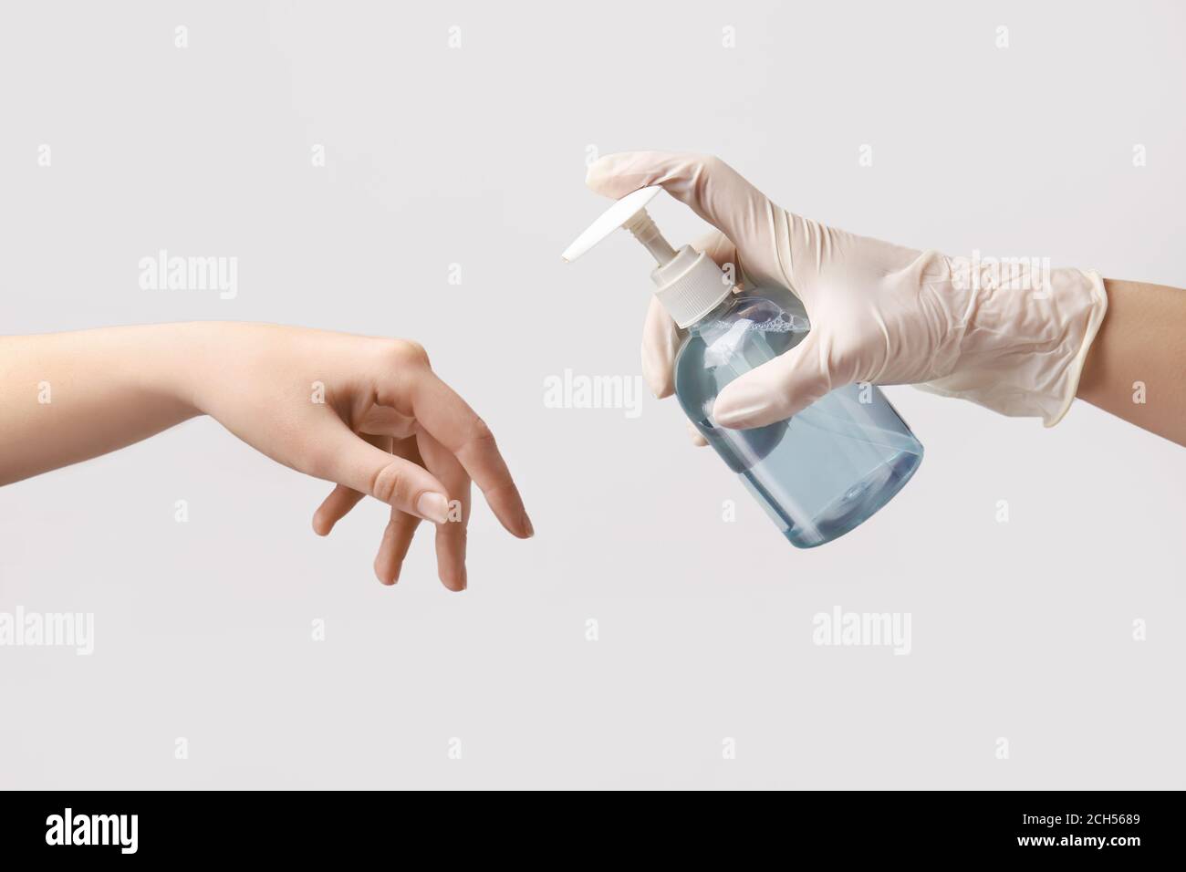 People disinfecting hands on light background Stock Photo - Alamy