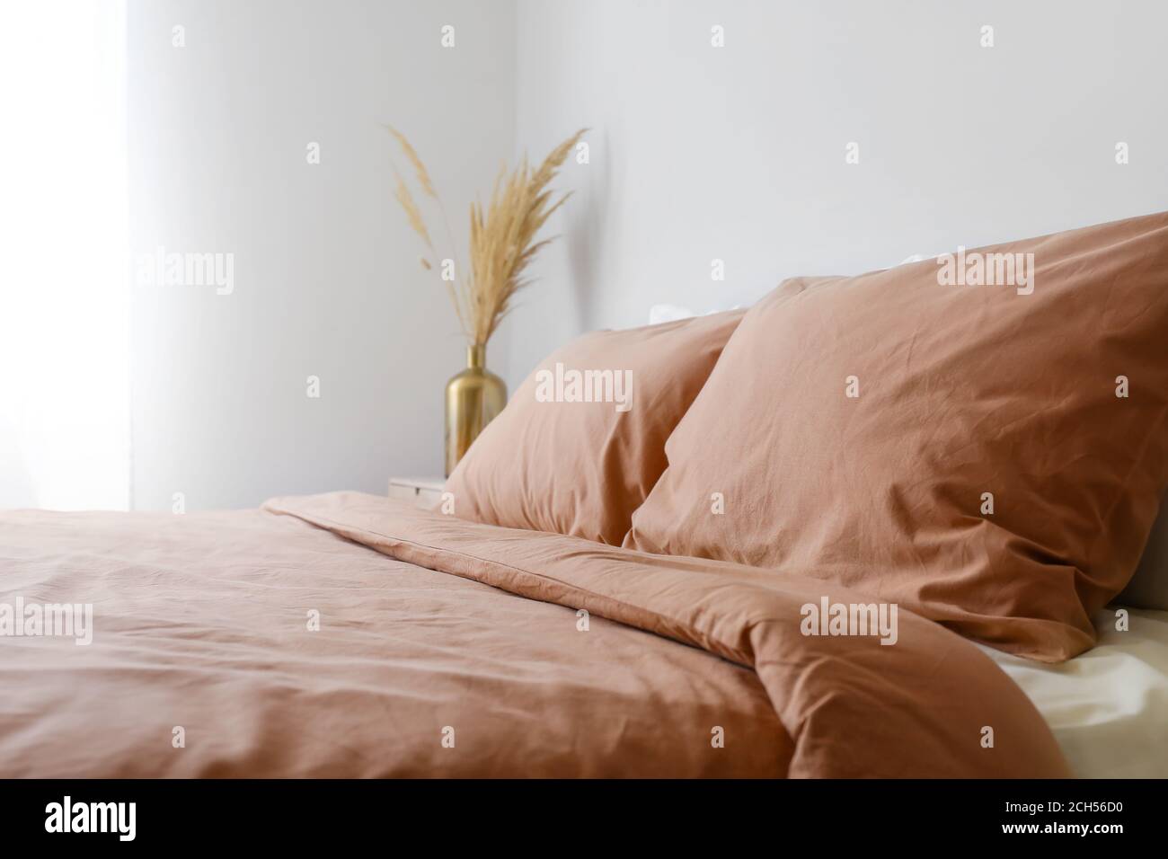 Big comfortable bed in room Stock Photo - Alamy