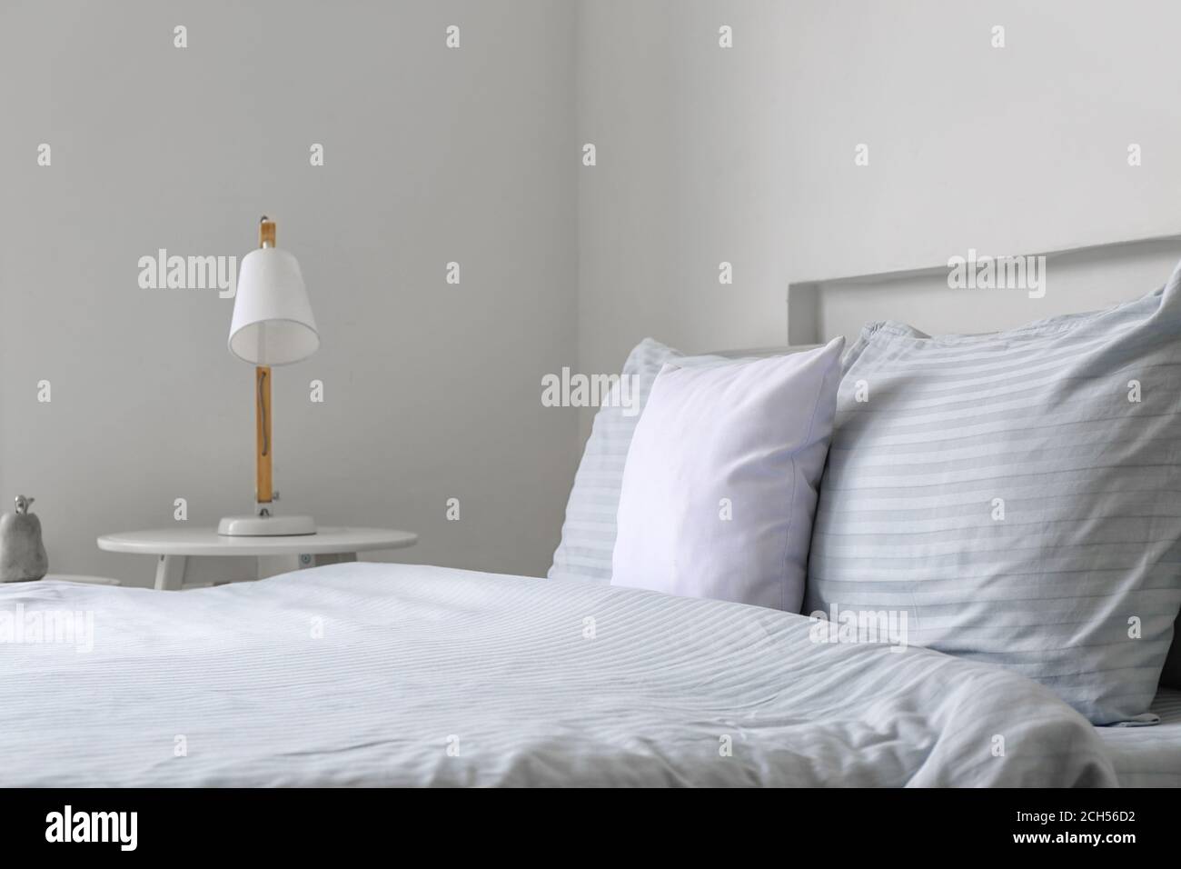 Big comfortable bed in room Stock Photo - Alamy
