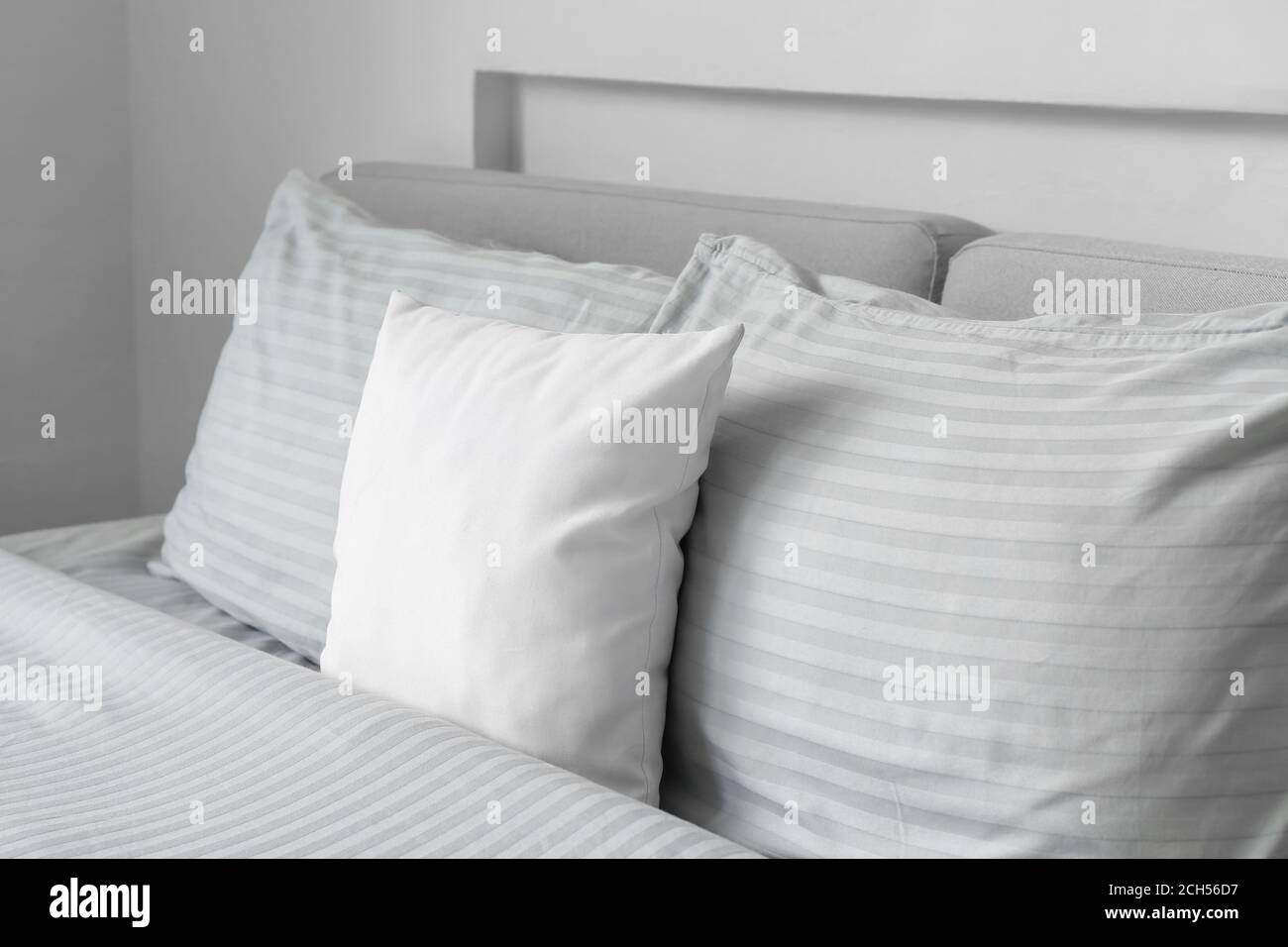 Big comfortable bed in room Stock Photo - Alamy