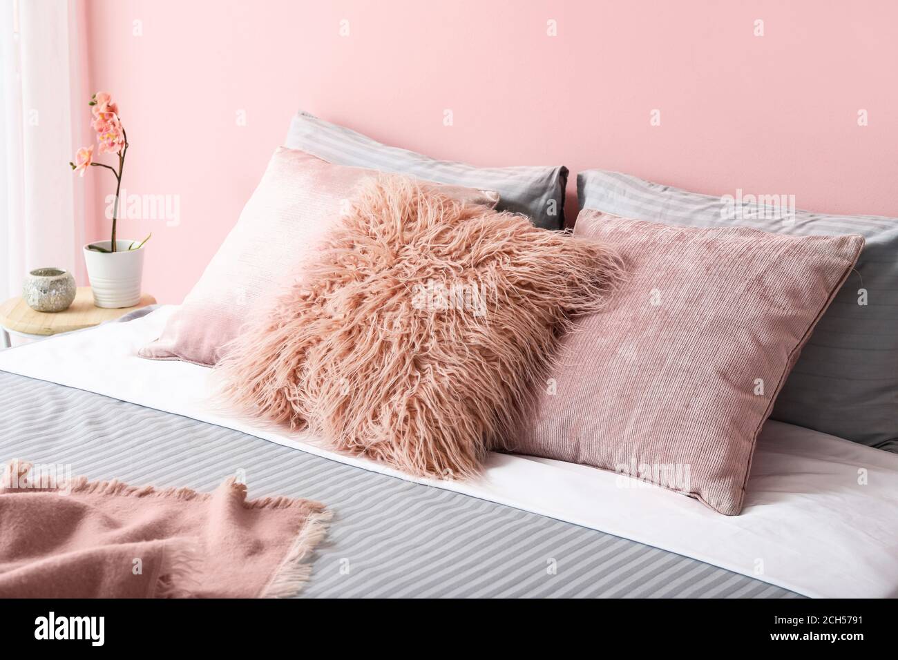 Big comfortable bed in room Stock Photo - Alamy
