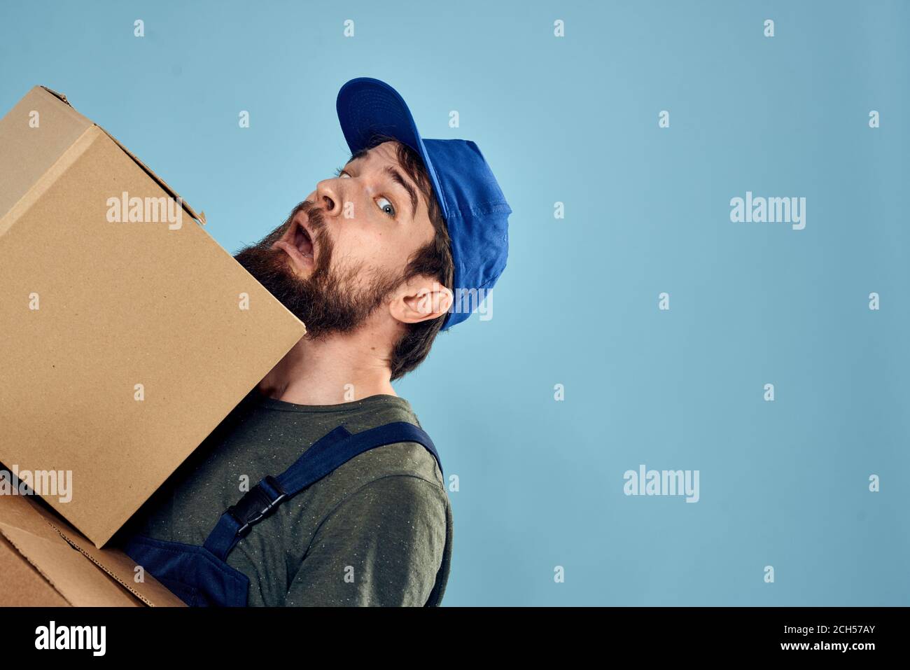 working man boxes in hands delivery service packaging lifestyle blue ...