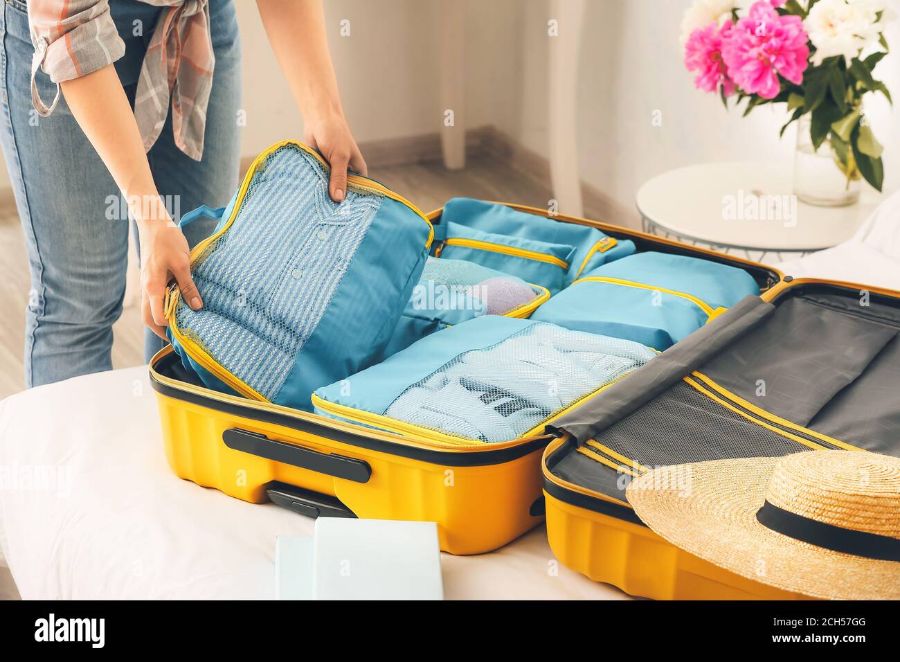 Woman packing clothes before journey at home Stock Photo - Alamy