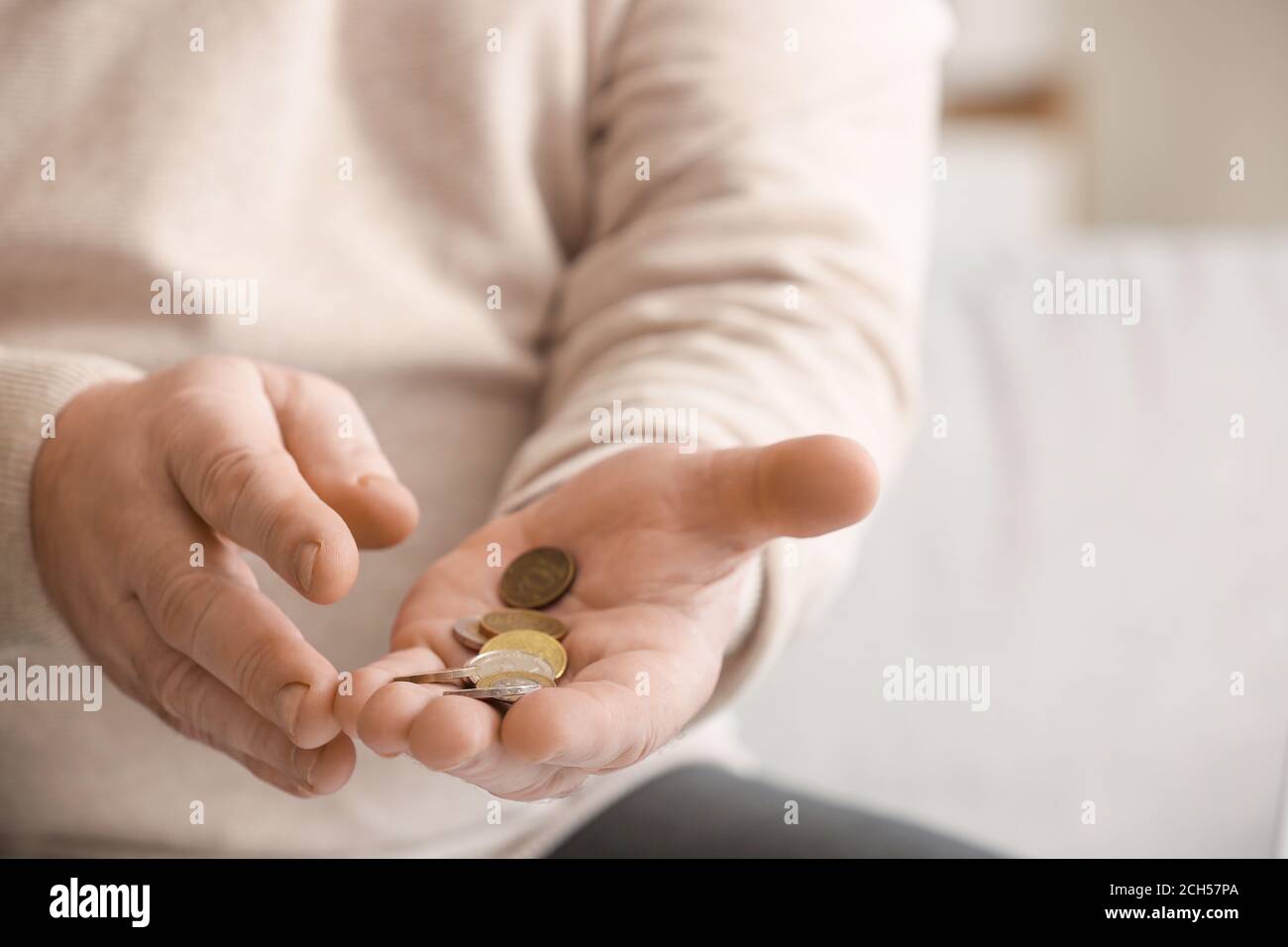 Senior man counting coins hi-res stock photography and images - Alamy