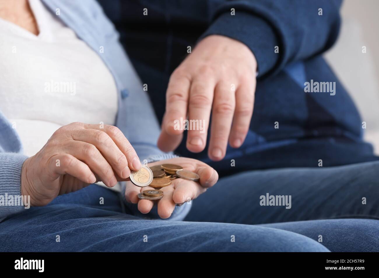 Aged man counting coins hi-res stock photography and images - Alamy