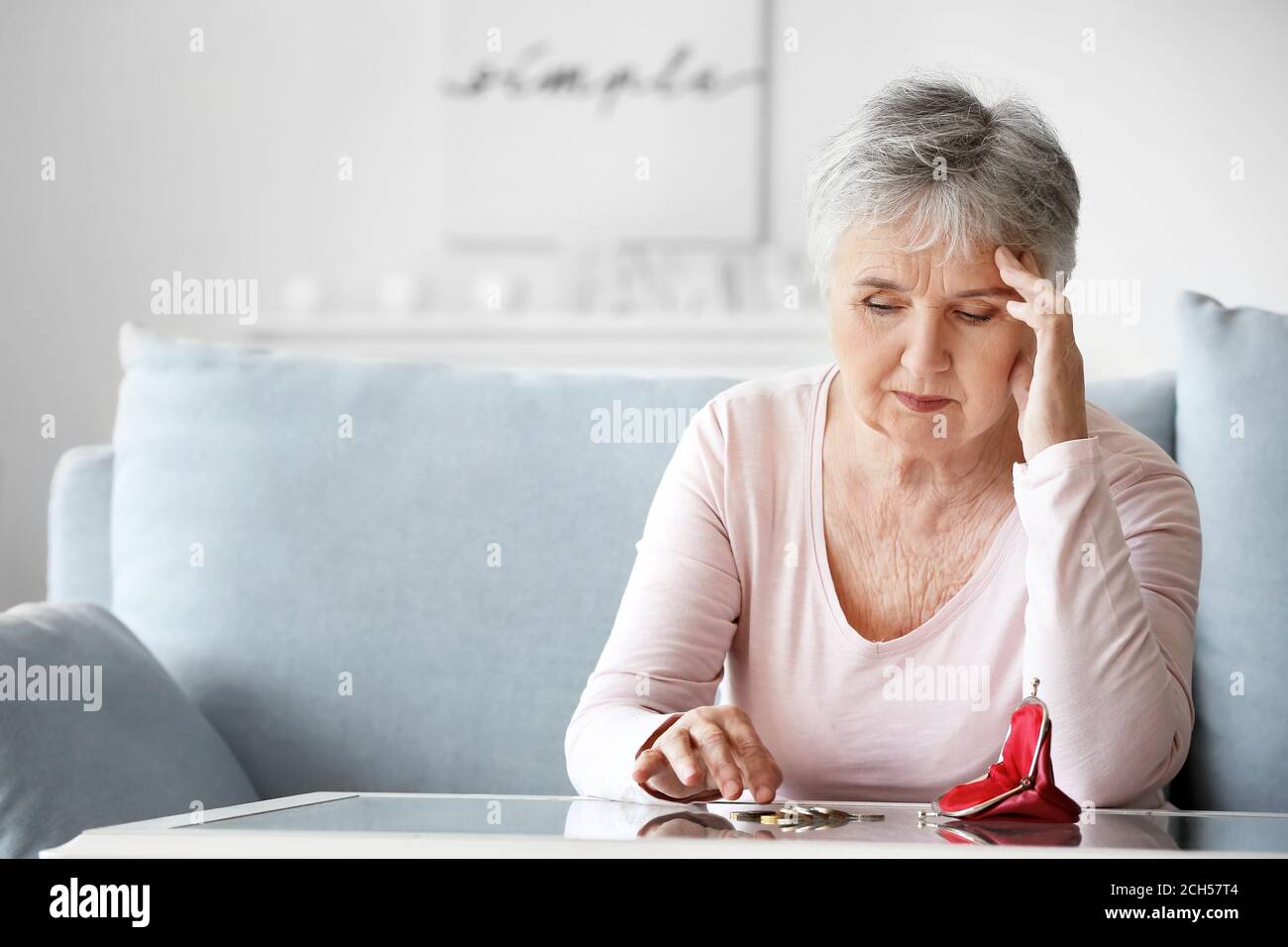 Sad senior woman counting money at home Stock Photo - Alamy