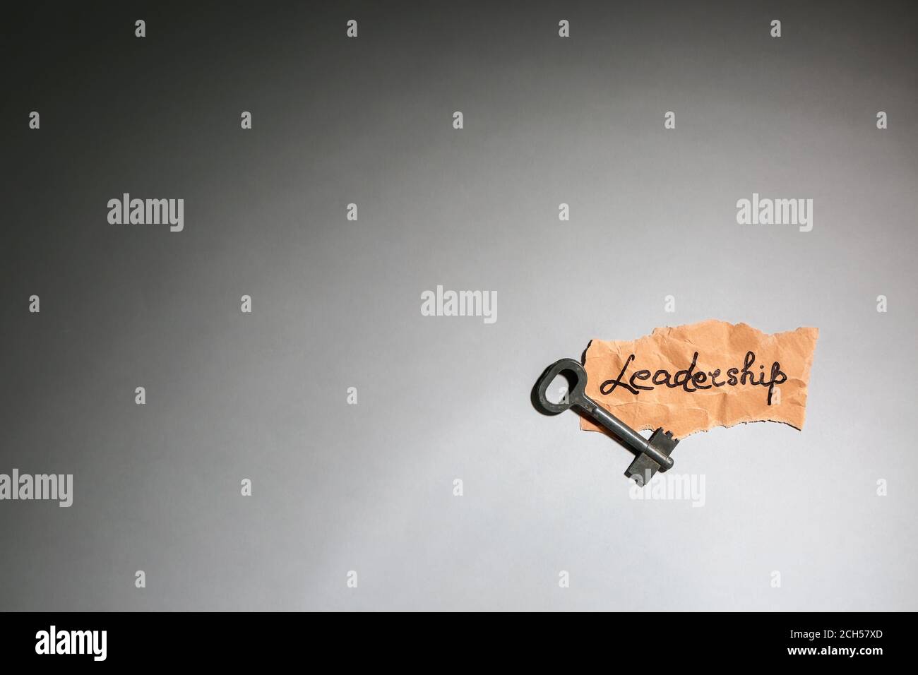 Key with word LEADERSHIP on grey background Stock Photo - Alamy