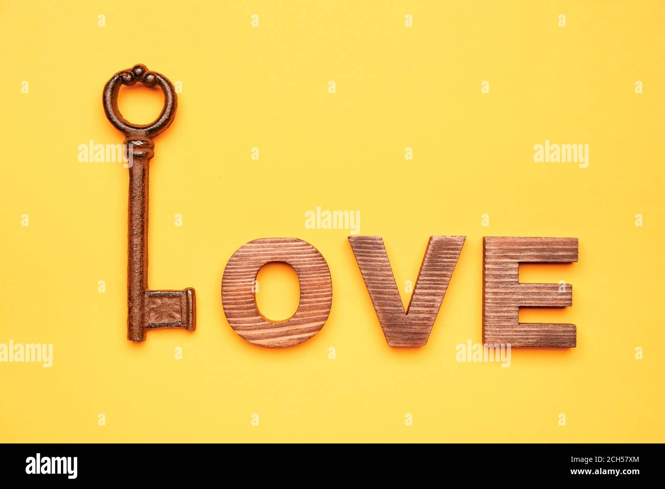 Word LOVE with key on color background Stock Photo - Alamy