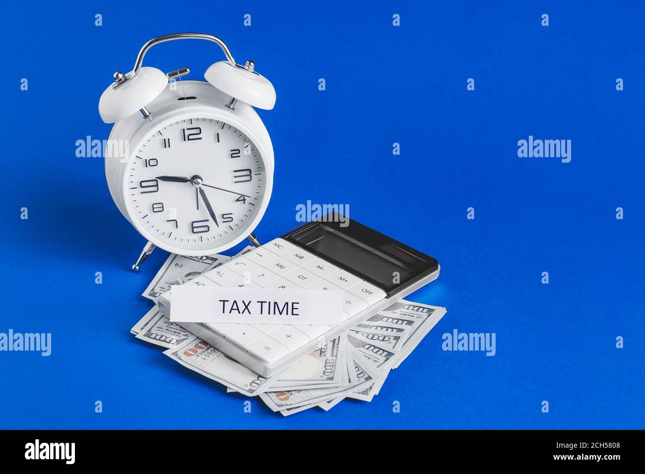 Alarm clock with calculator and money on color background. Concept of ...