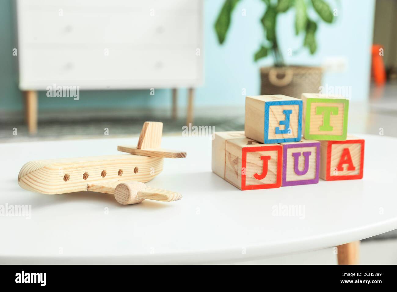 Children's toys on table in room Stock Photo - Alamy