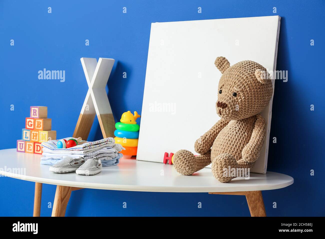 Children's toys with accessories on table in room Stock Photo - Alamy