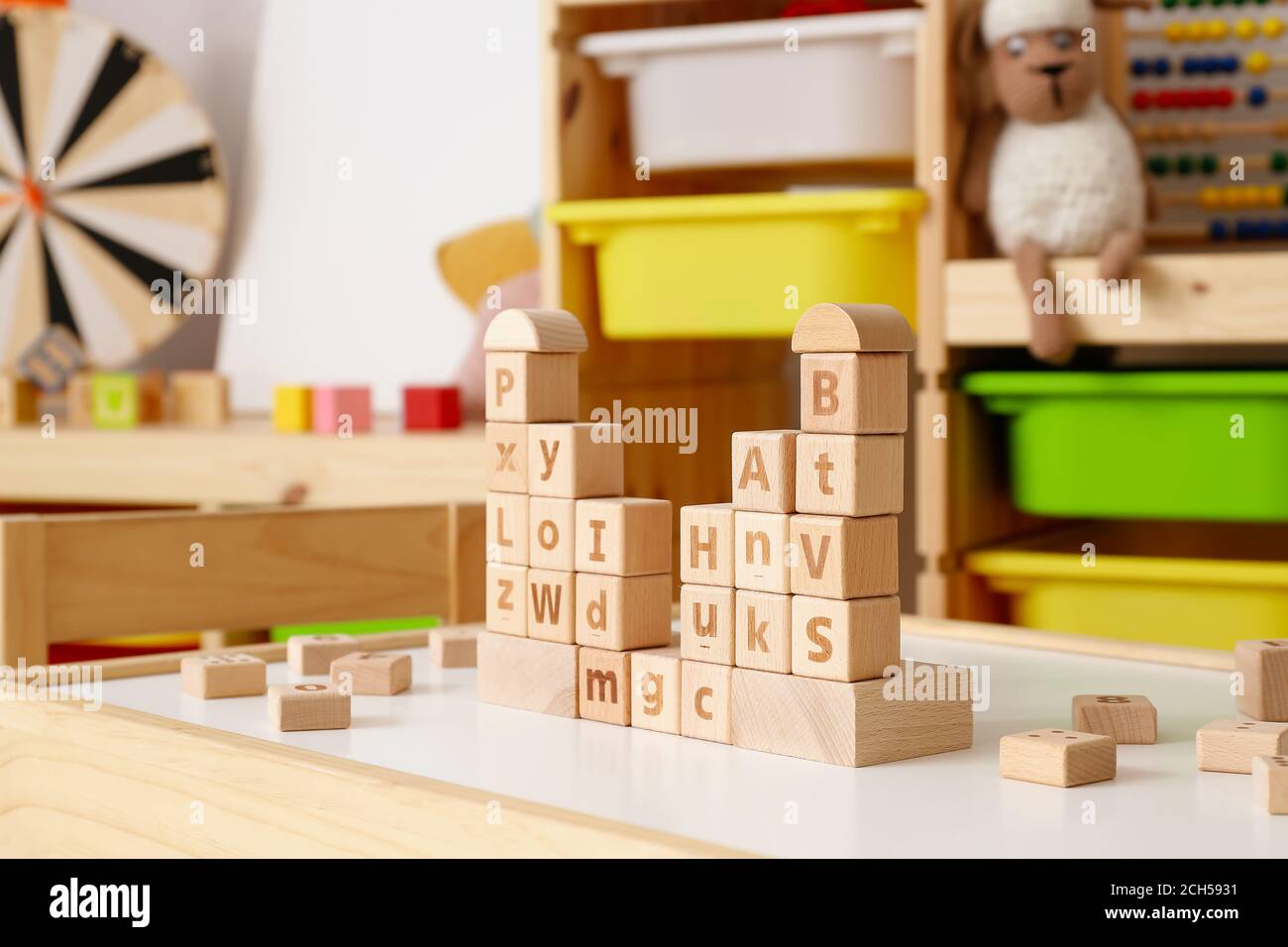 Wooden cubes on table in children's room Stock Photo - Alamy