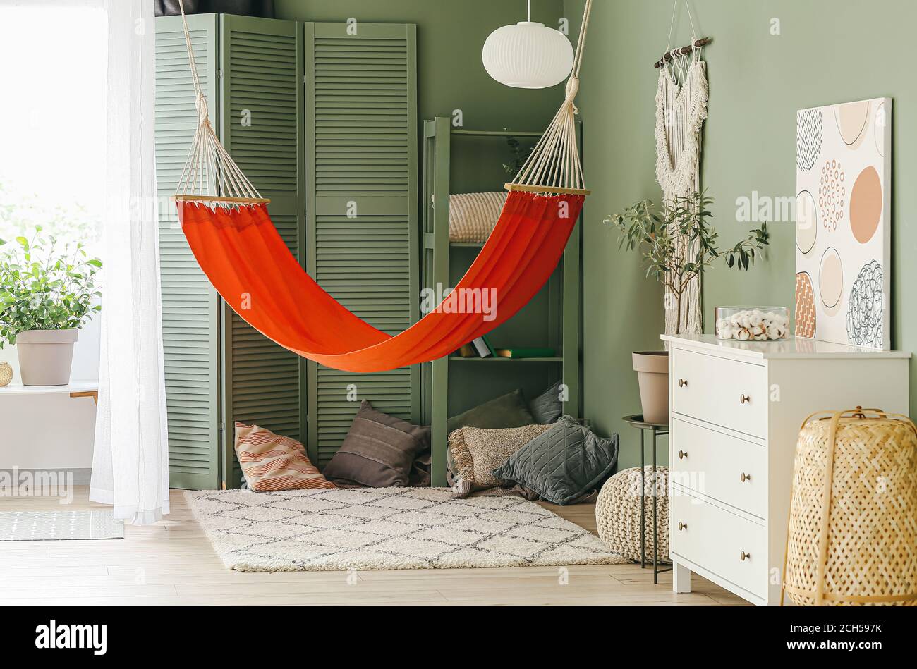 Interior of living room with stylish hammock Stock Photo - Alamy