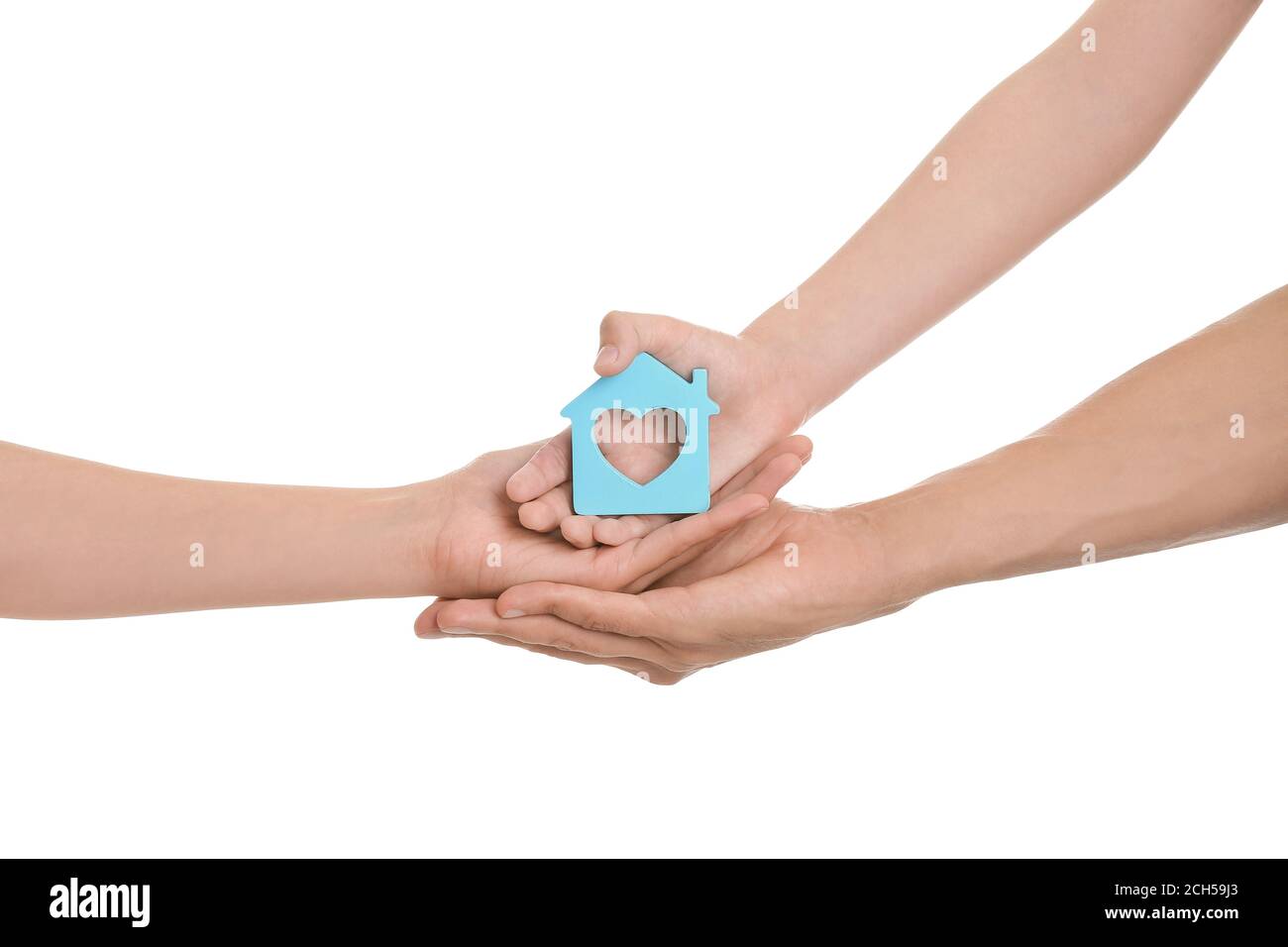Hands of family with small house on white background Stock Photo - Alamy