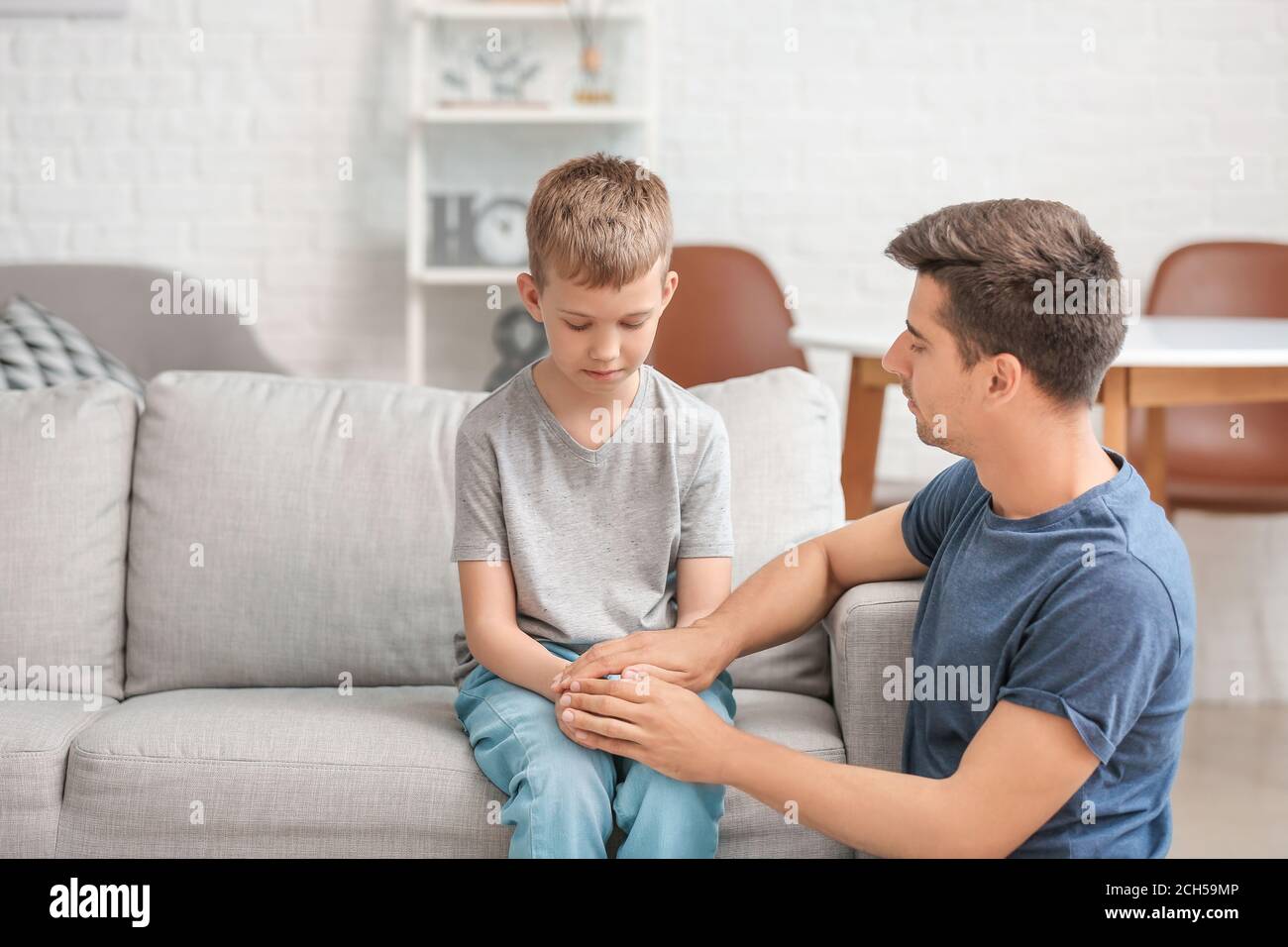 Father trying to make peace with son after quarrel at home Stock Photo ...