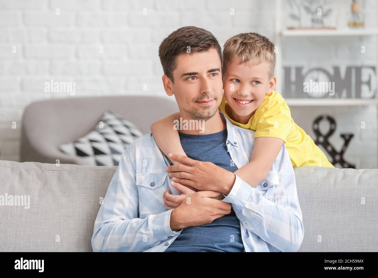 Happy father and son hugging after quarrel at home Stock Photo - Alamy