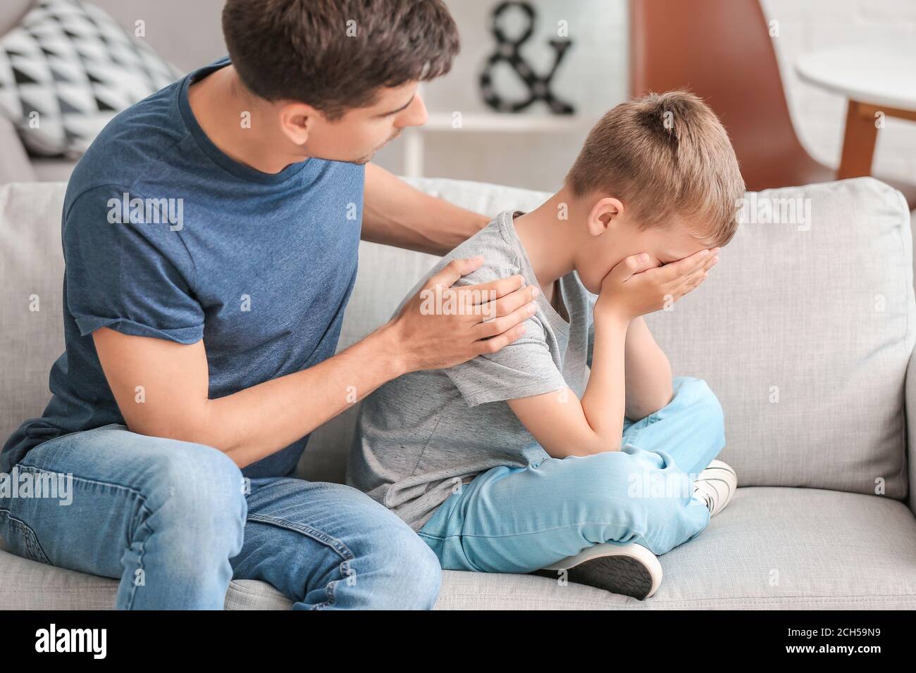 Father trying to make peace with son after quarrel at home Stock Photo ...