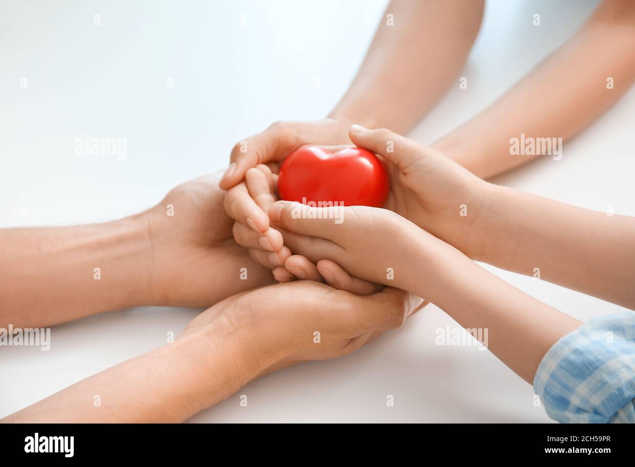 Hands of family with heart on white background Stock Photo - Alamy
