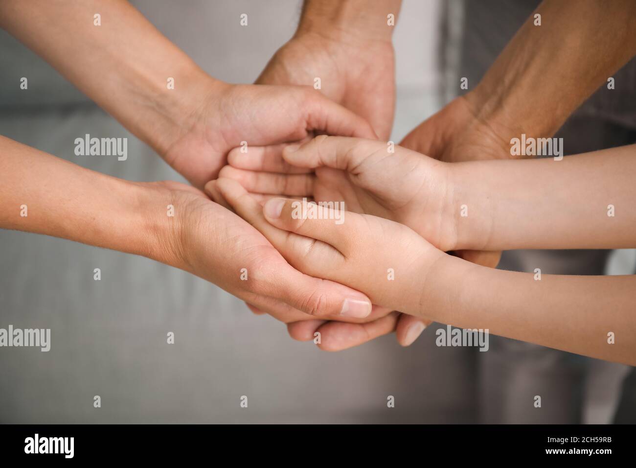 Family holding hands together at home, closeup Stock Photo - Alamy
