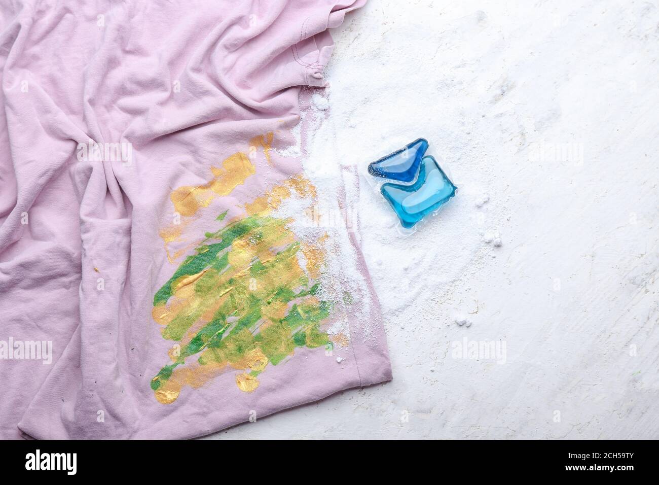 Dirty clothes with detergent on white background Stock Photo - Alamy
