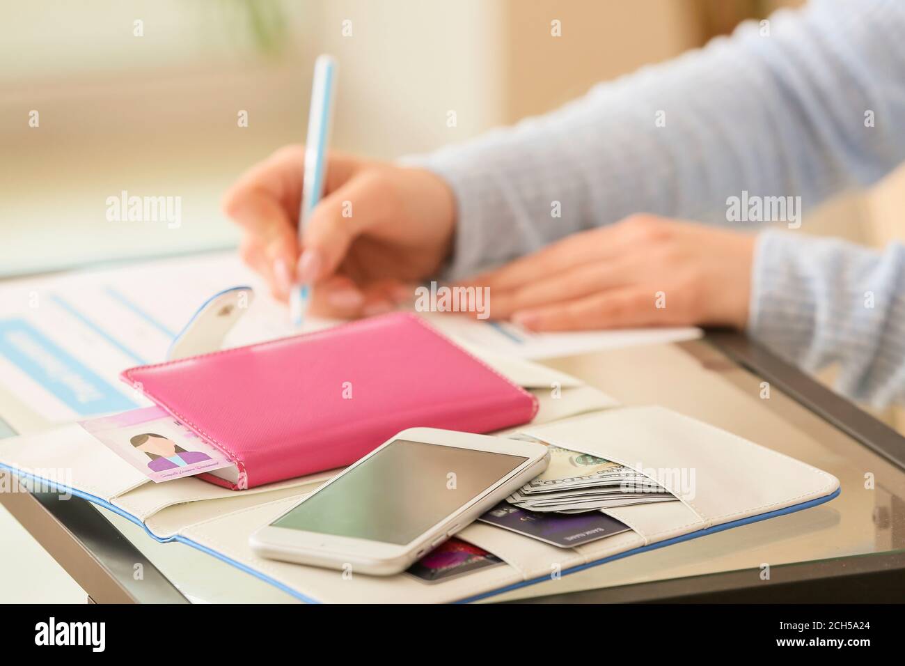 Woman with travel organizer at table Stock Photo - Alamy