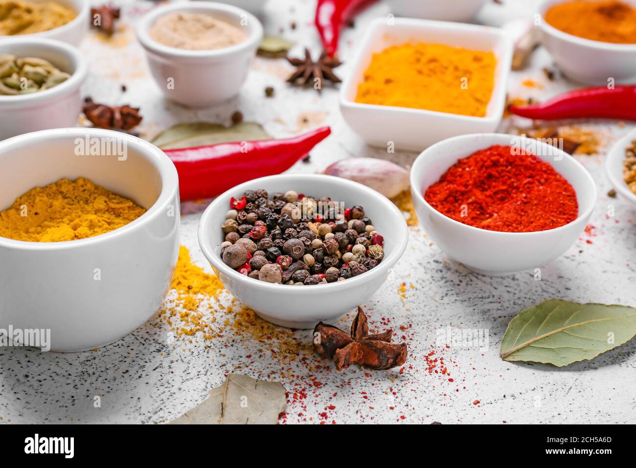 Bowls with different aromatic spices on white background Stock Photo ...
