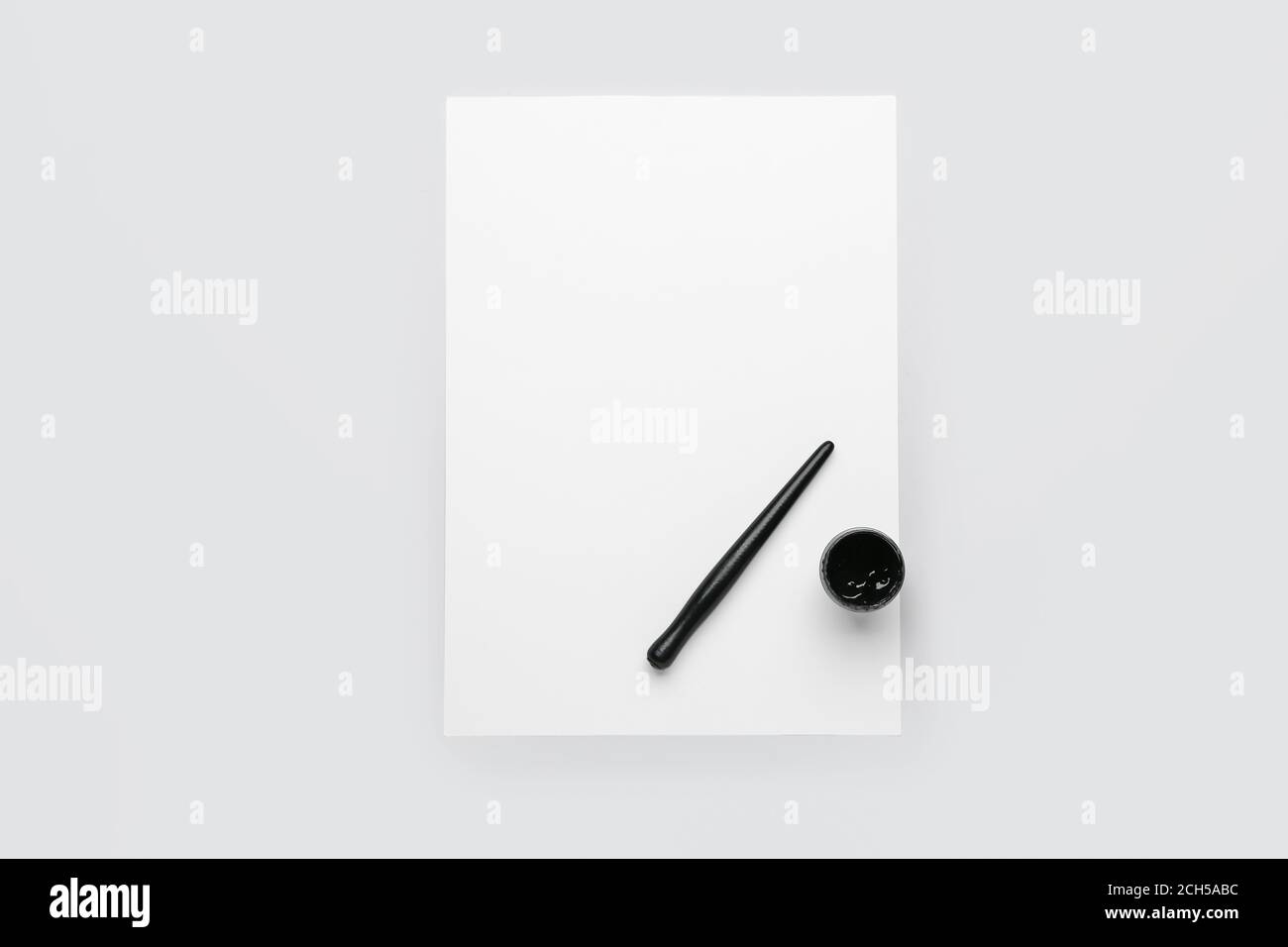Sheet of paper, nib pen and ink on white background Stock Photo - Alamy