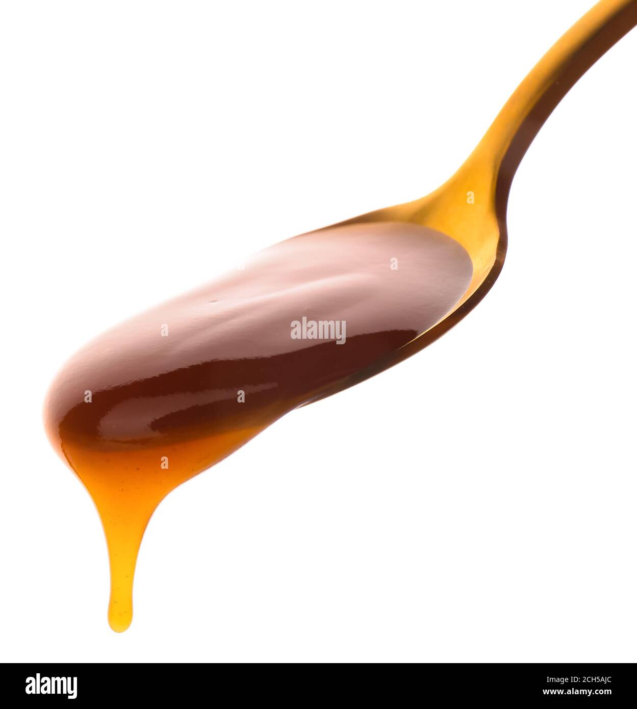 Spoon with liquid caramel on white background Stock Photo - Alamy