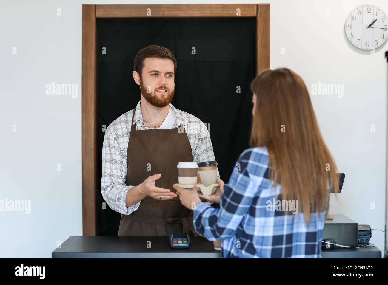 Male barista and client in modern cafe Stock Photo - Alamy