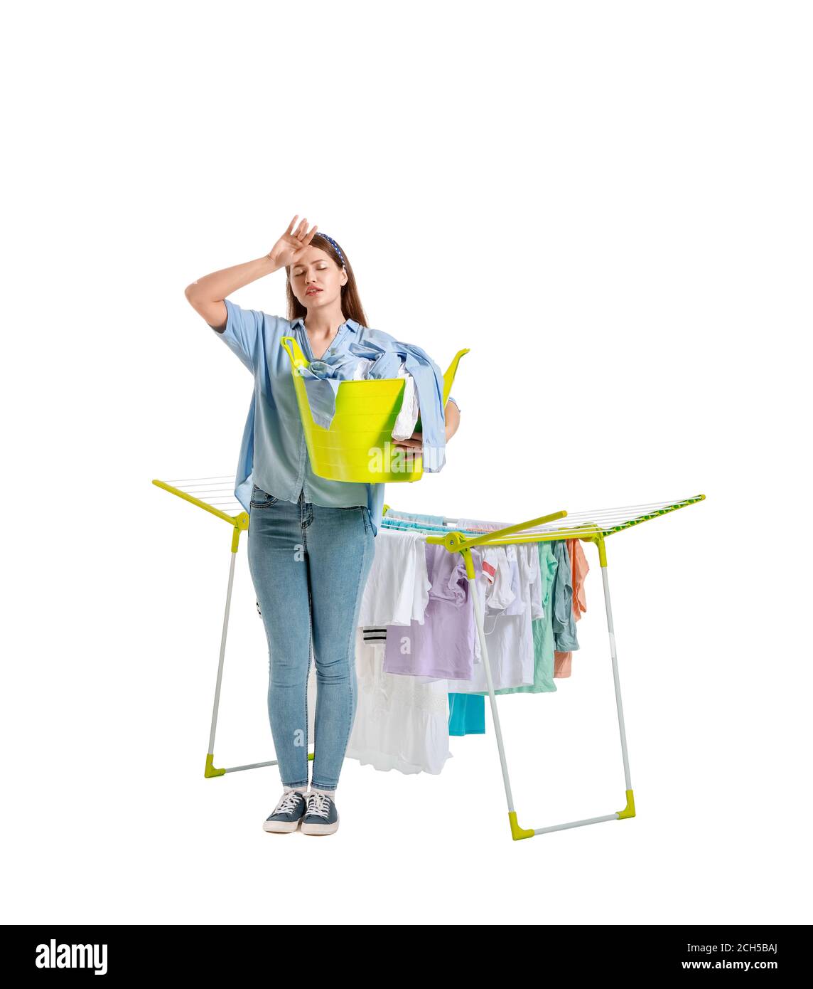 Tired woman with clean clothes and dryer on white background Stock ...
