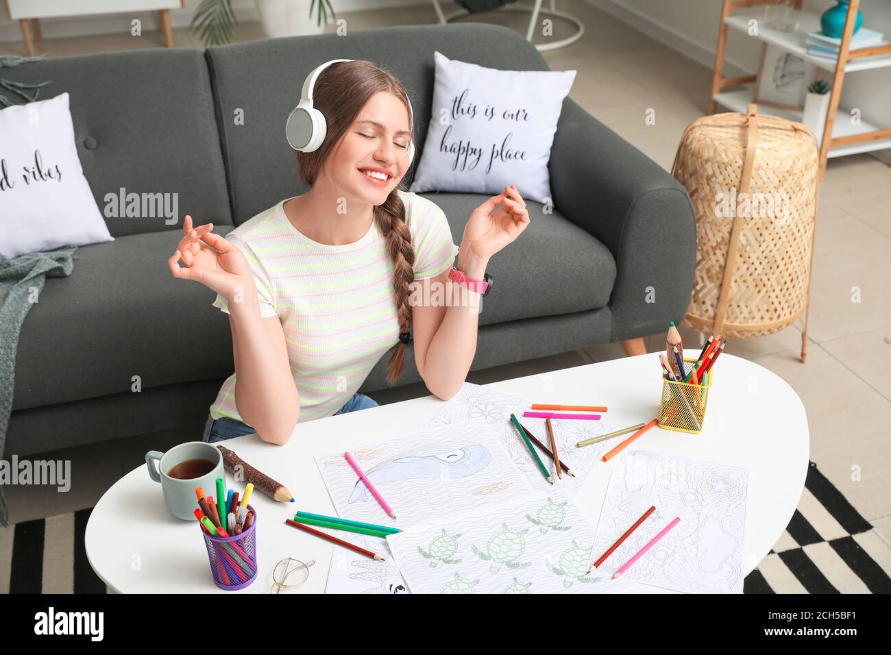 Young woman coloring picture at home Stock Photo - Alamy