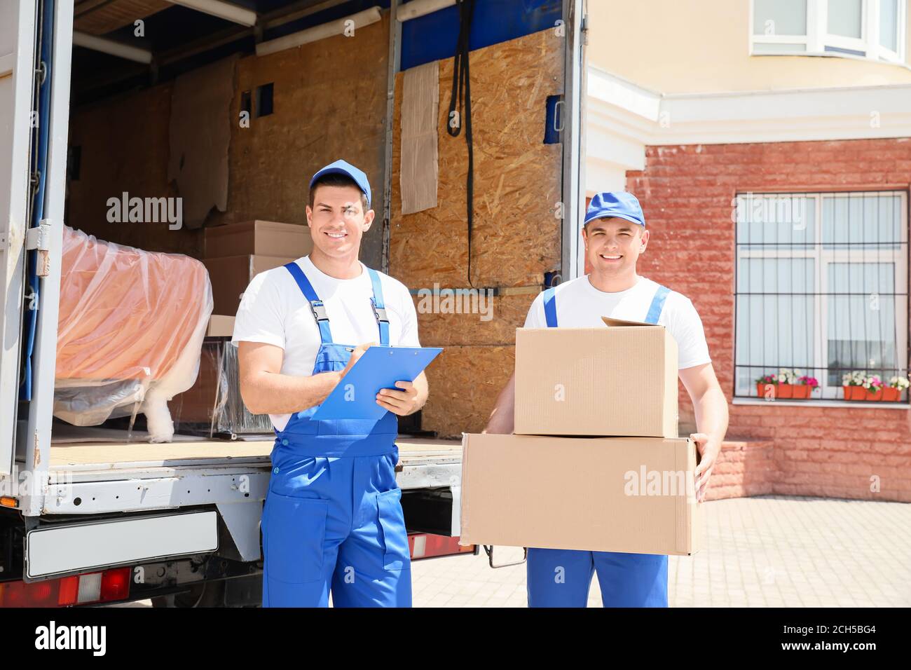 Loaders taking freight from truck Stock Photo - Alamy